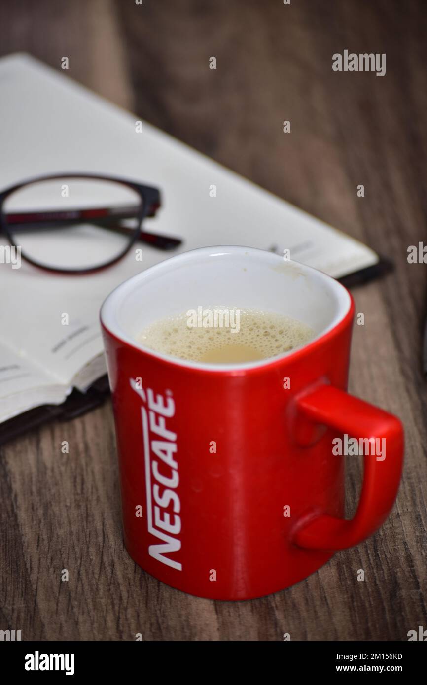 Nescafe coffee cup at office table Stock Photo - Alamy