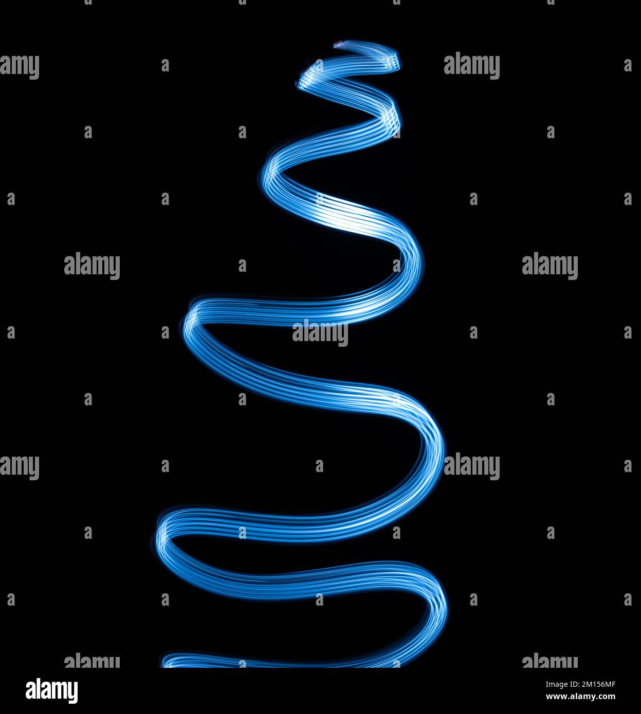 Magic blue light spirals on black background Stock Photo - Alamy