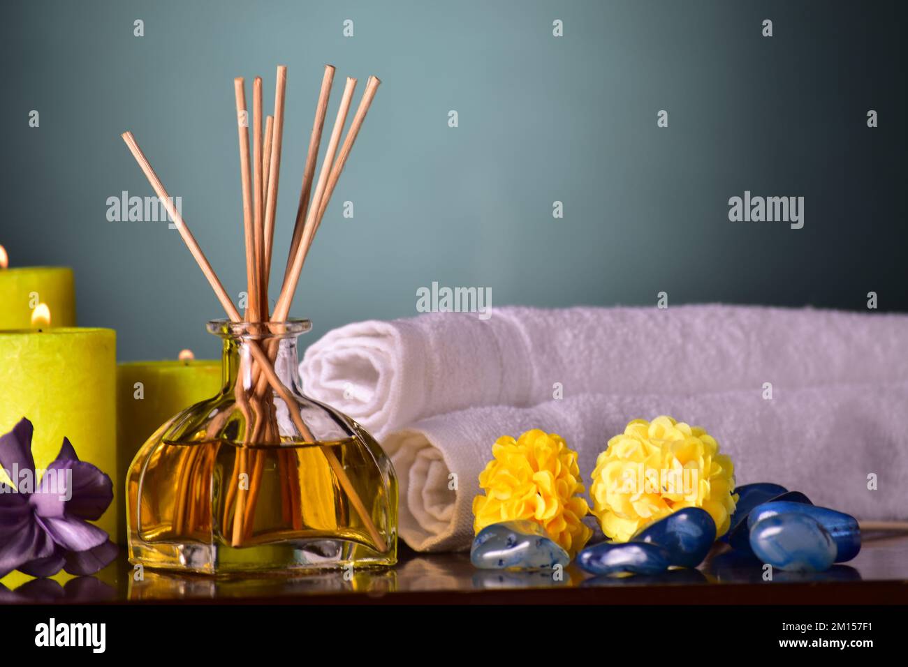 reed diffuser with flowers and stone Stock Photo - Alamy