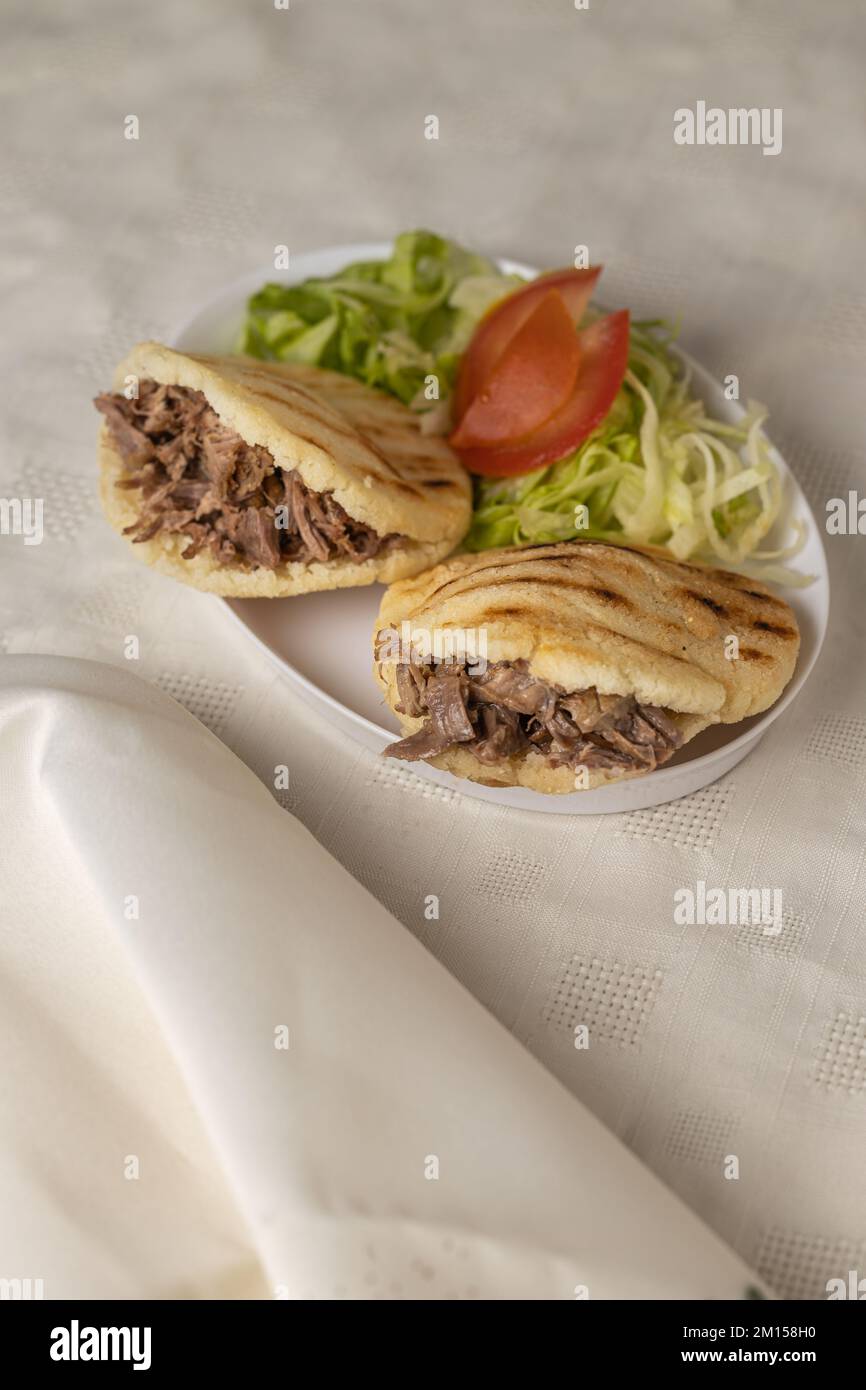 Arepas, typical Venezuelan food, made with maize and filled with ...
