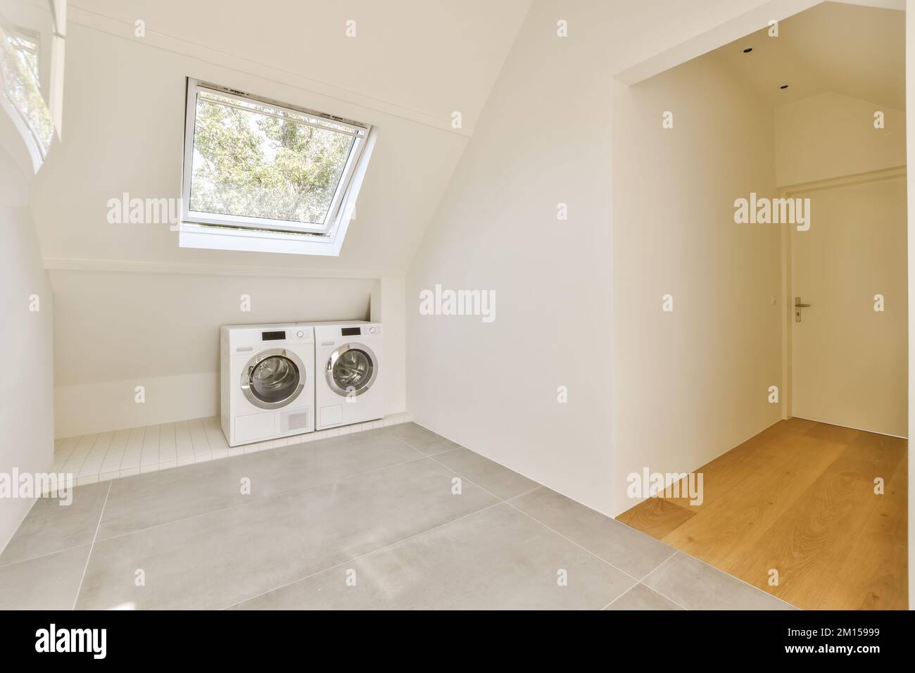 an empty laundry room with a washing machine and dryer in the corner on ...