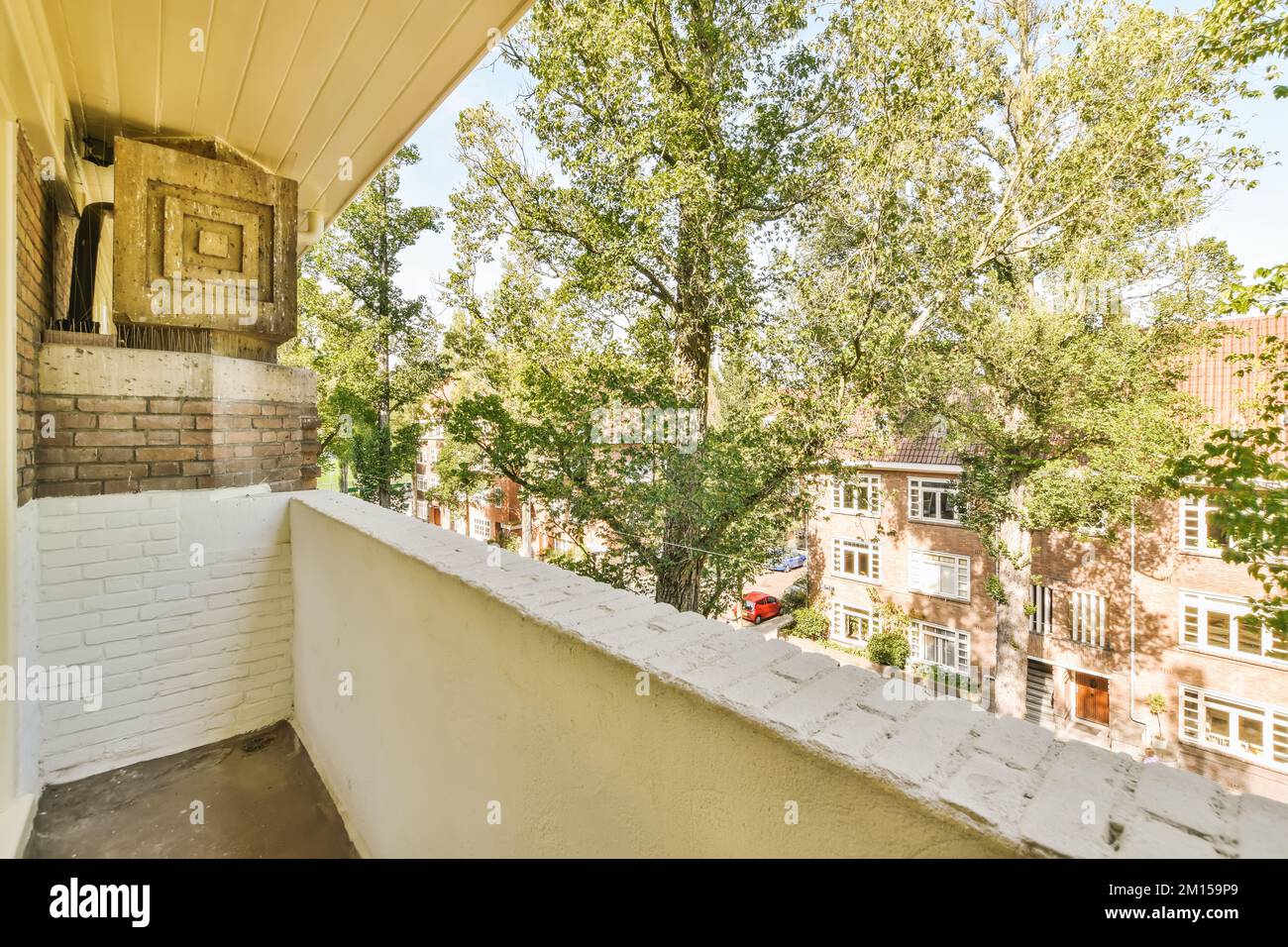 a balcony with trees and buildings in the background, as seen from an ...