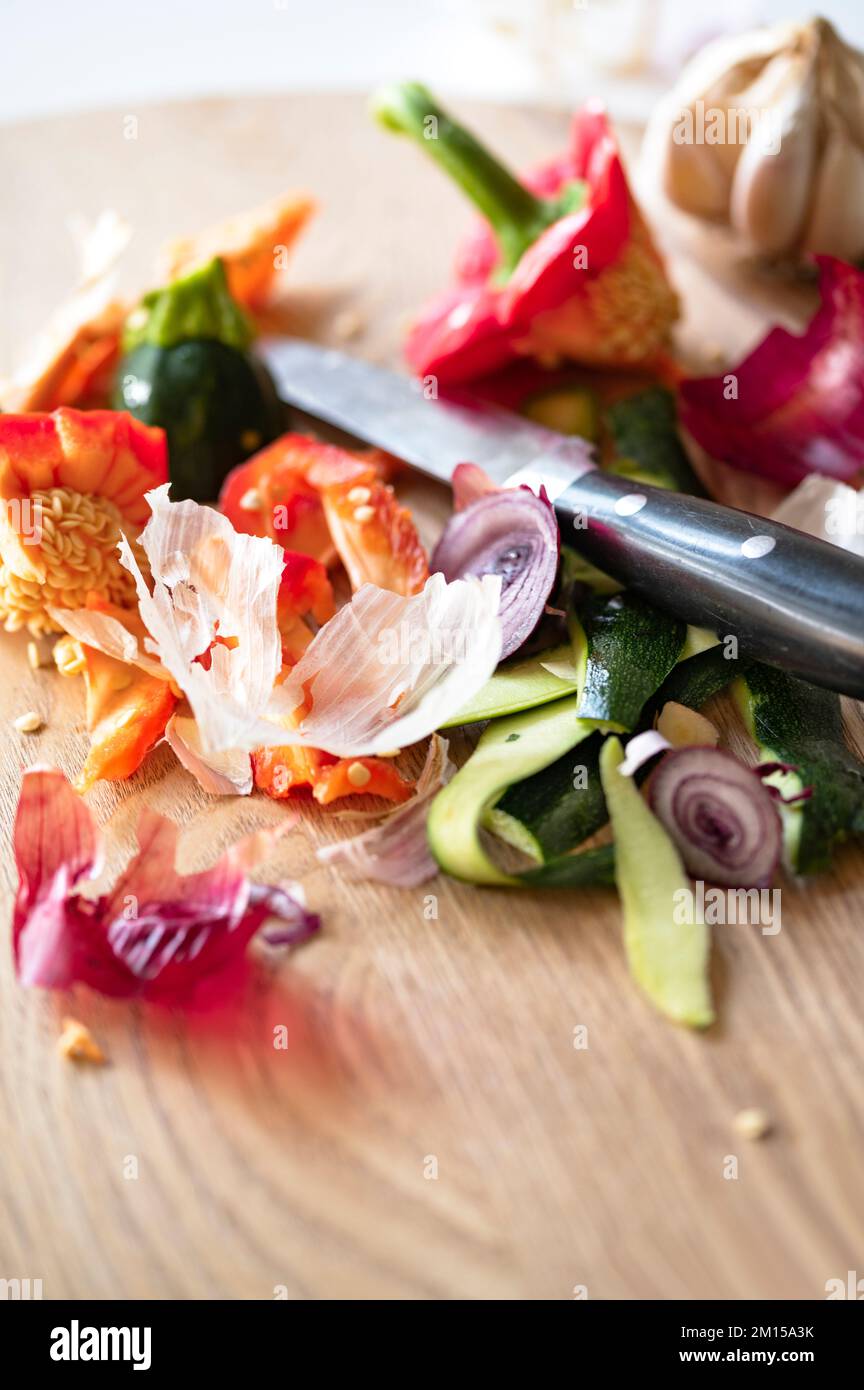 Vegetable leftovers with knife on the kitchen table Stock Photo - Alamy