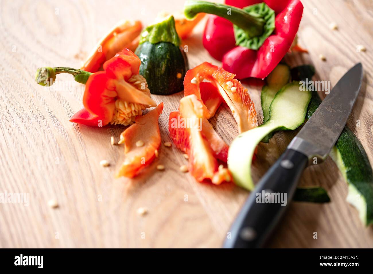 Vegetable leftovers with knife on the kitchen table Stock Photo - Alamy
