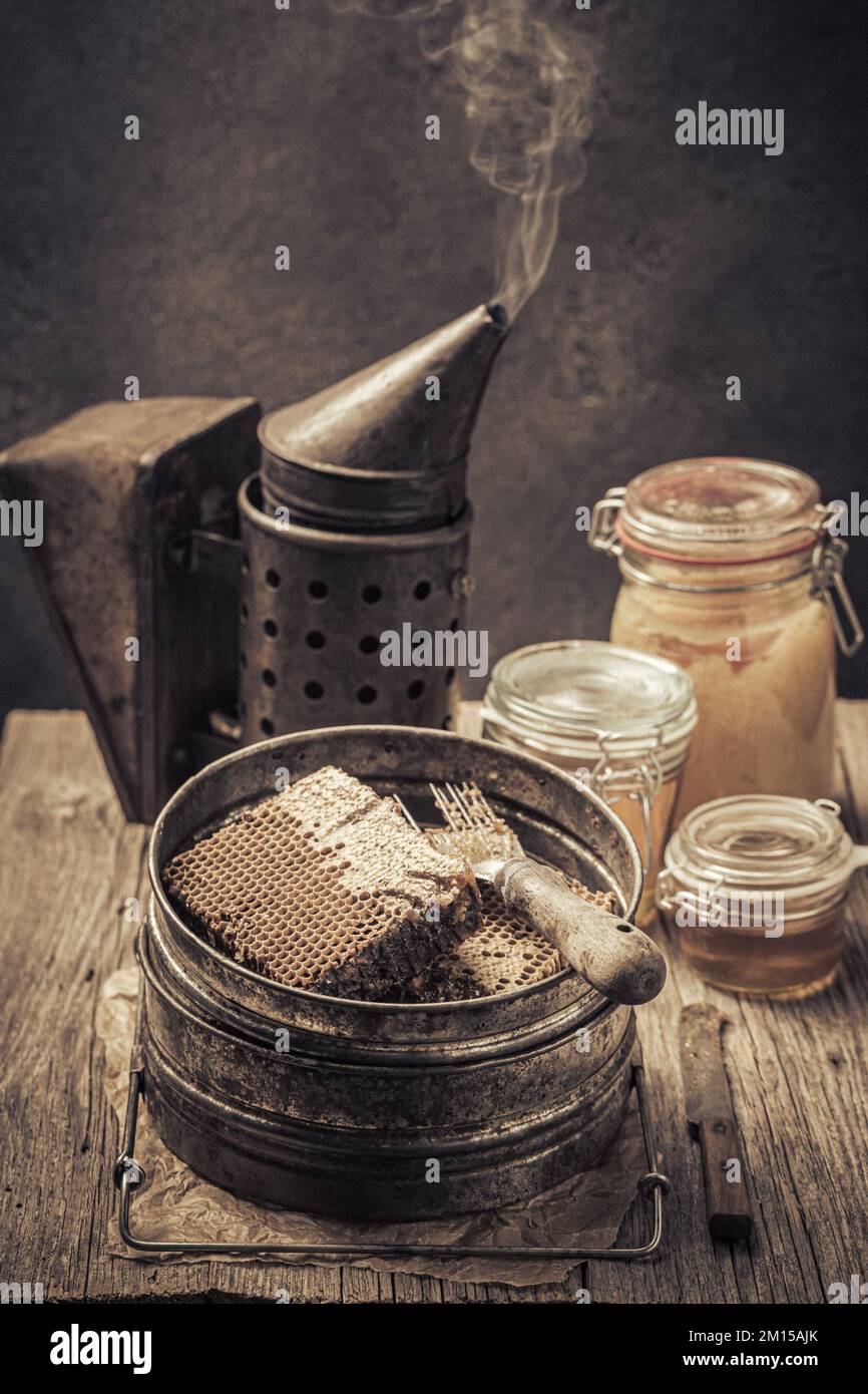 Classic tools for the beekeeper with beekeeping knot full of honey ...