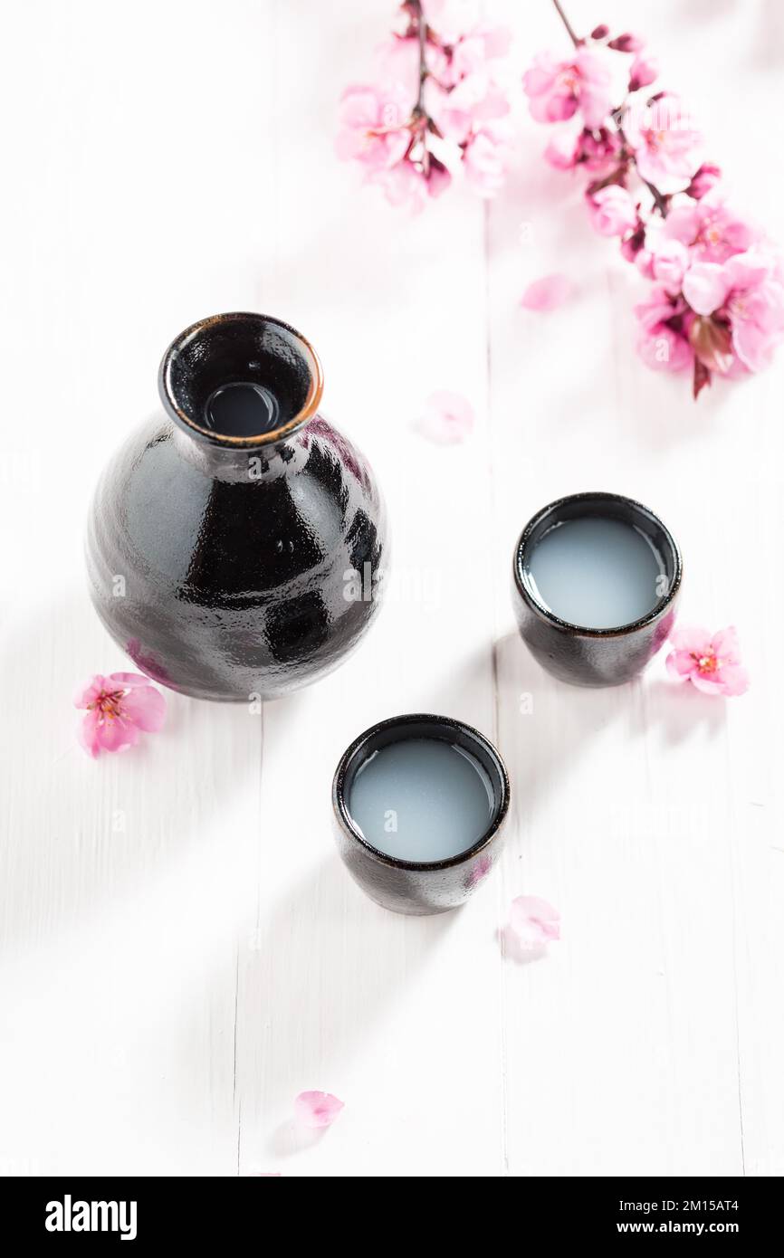 Traditional Japanese sake with blooming pink flowers. Method of serving ...