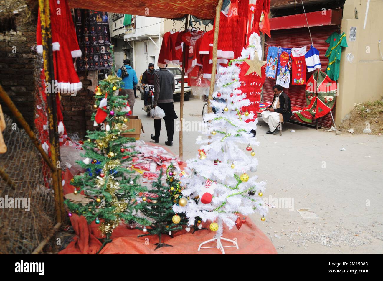 ISLAMABAD, PAKISTAN.A vendor is displaying and selling Santa Claus ...