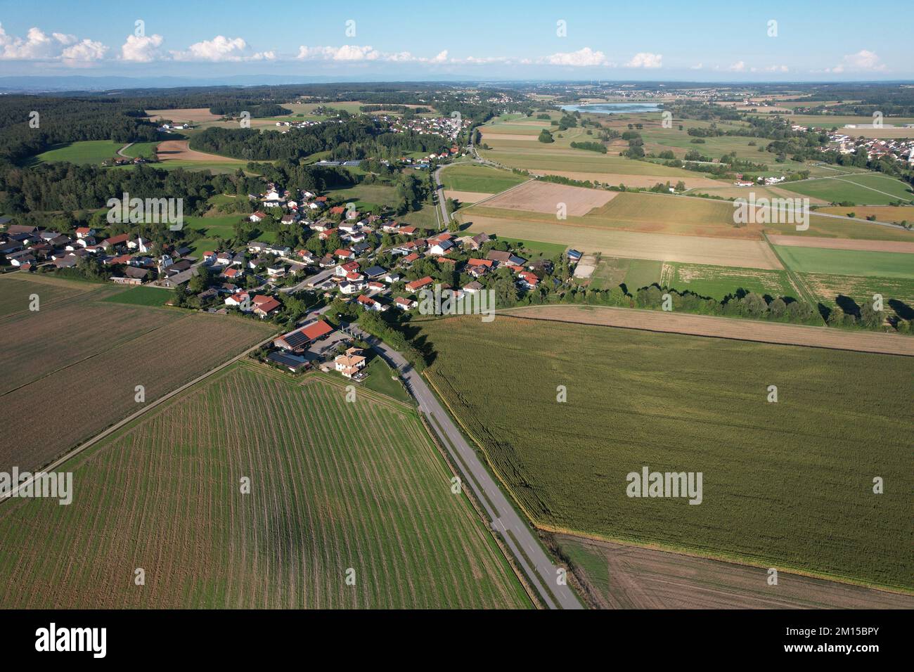 An aerial view of a village surrounded by agricultural fields and ...