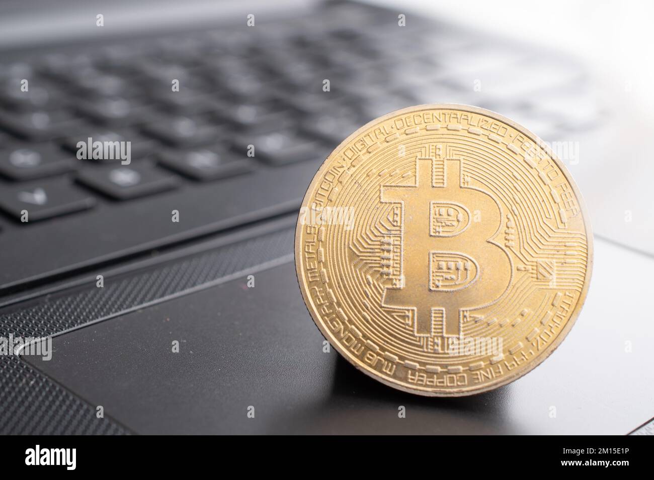 Closeup of bitcoin on computer table Stock Photo - Alamy