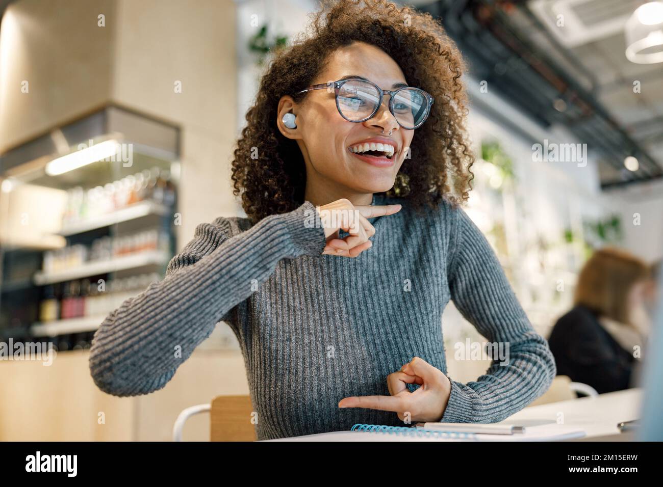 Smiling african woman speaks sign language with friends by video call ...
