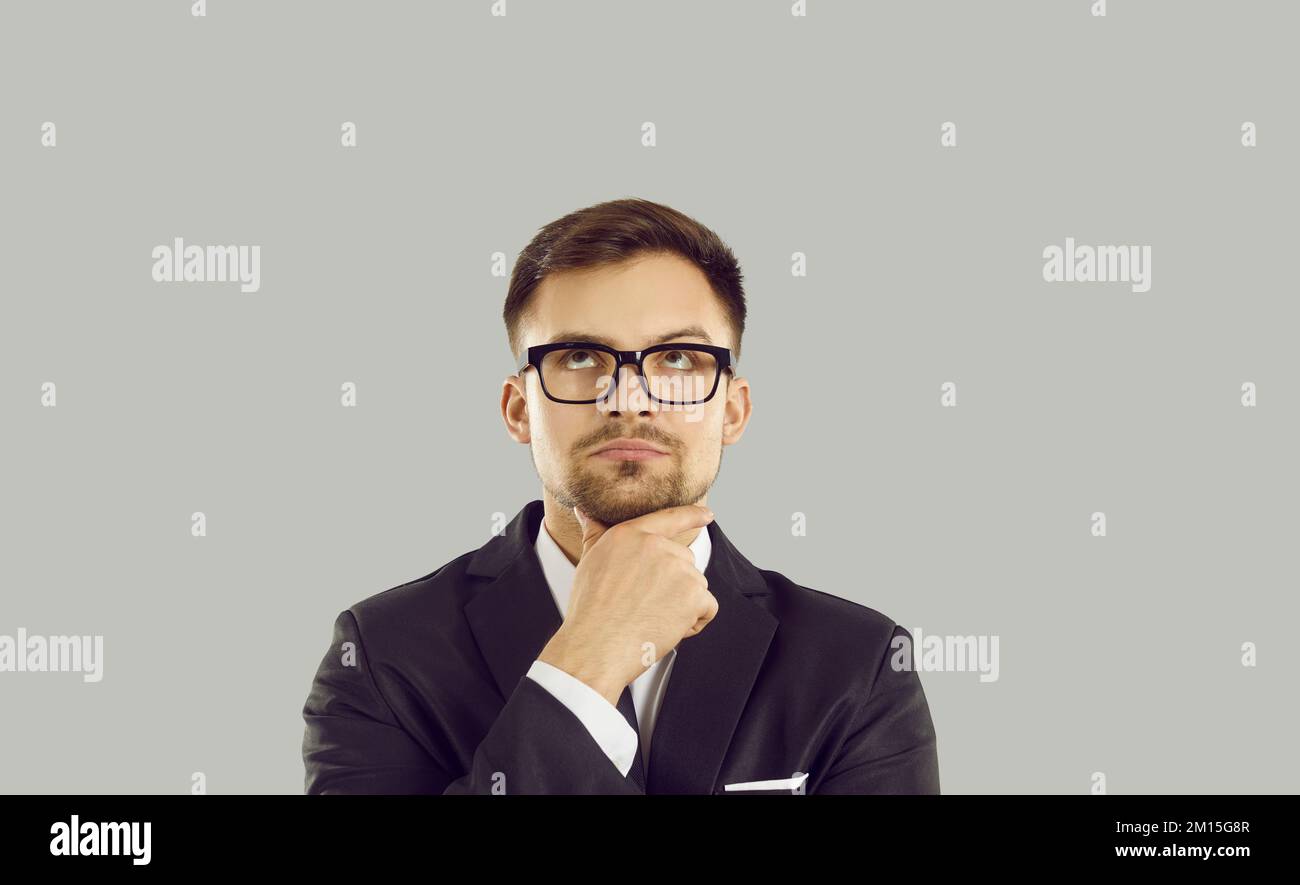 Serious businessman with doubtful uncertain facial expression hesitates ...