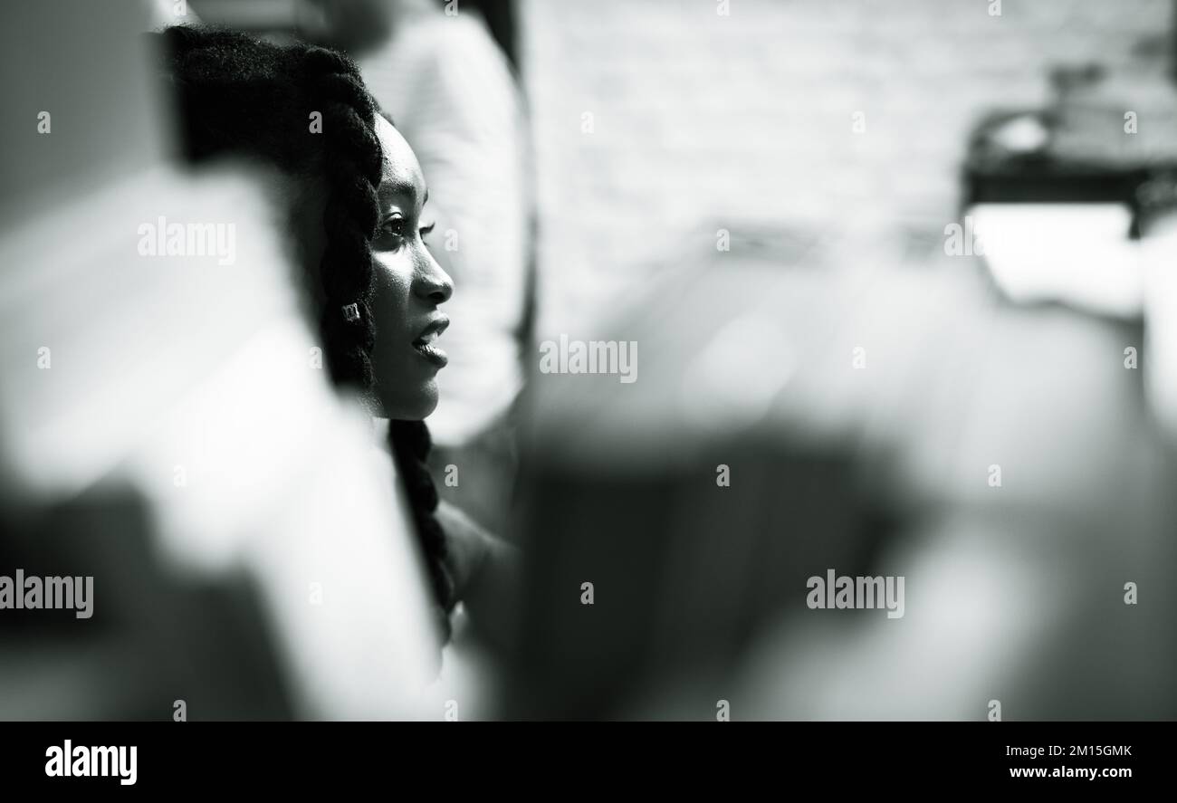 Focused young african american lady working or studying in library ...