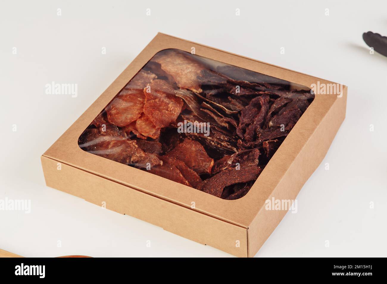 Some craft cardboard boxes with dehydrated dog treats, the highest one ...