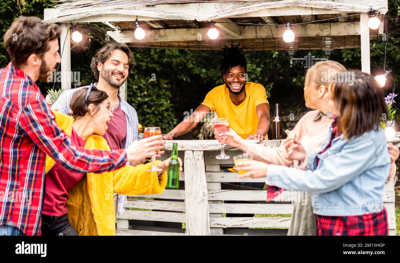 Happy mixed race people having fun at pool party on the rooftop while ...