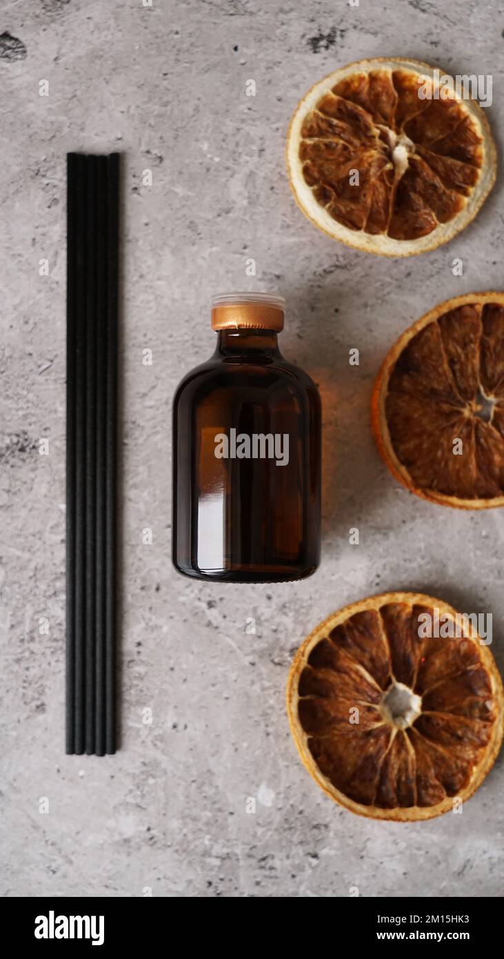 Citrus reed diffuser, dark background. Homemade diffuser. Creating cozy ...