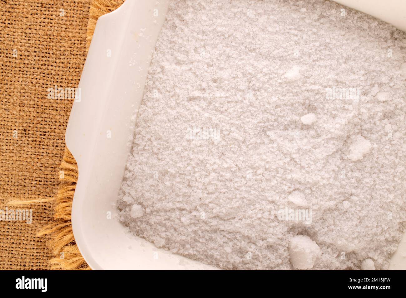 Rock salt in a ceramic bowl on a jute cloth, macro, top view Stock ...