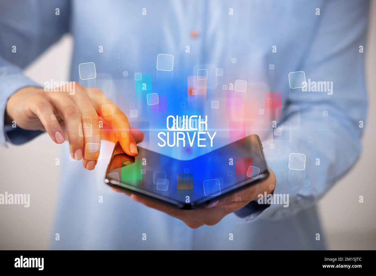 Young man holding a foldable smartphone Stock Photo - Alamy