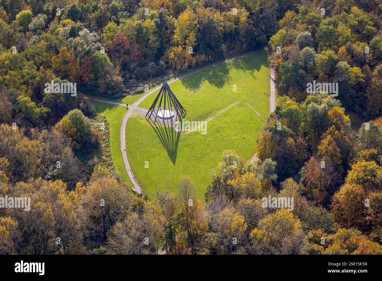 Aerial view, pyramid sculpture with shadow cast in health park ...