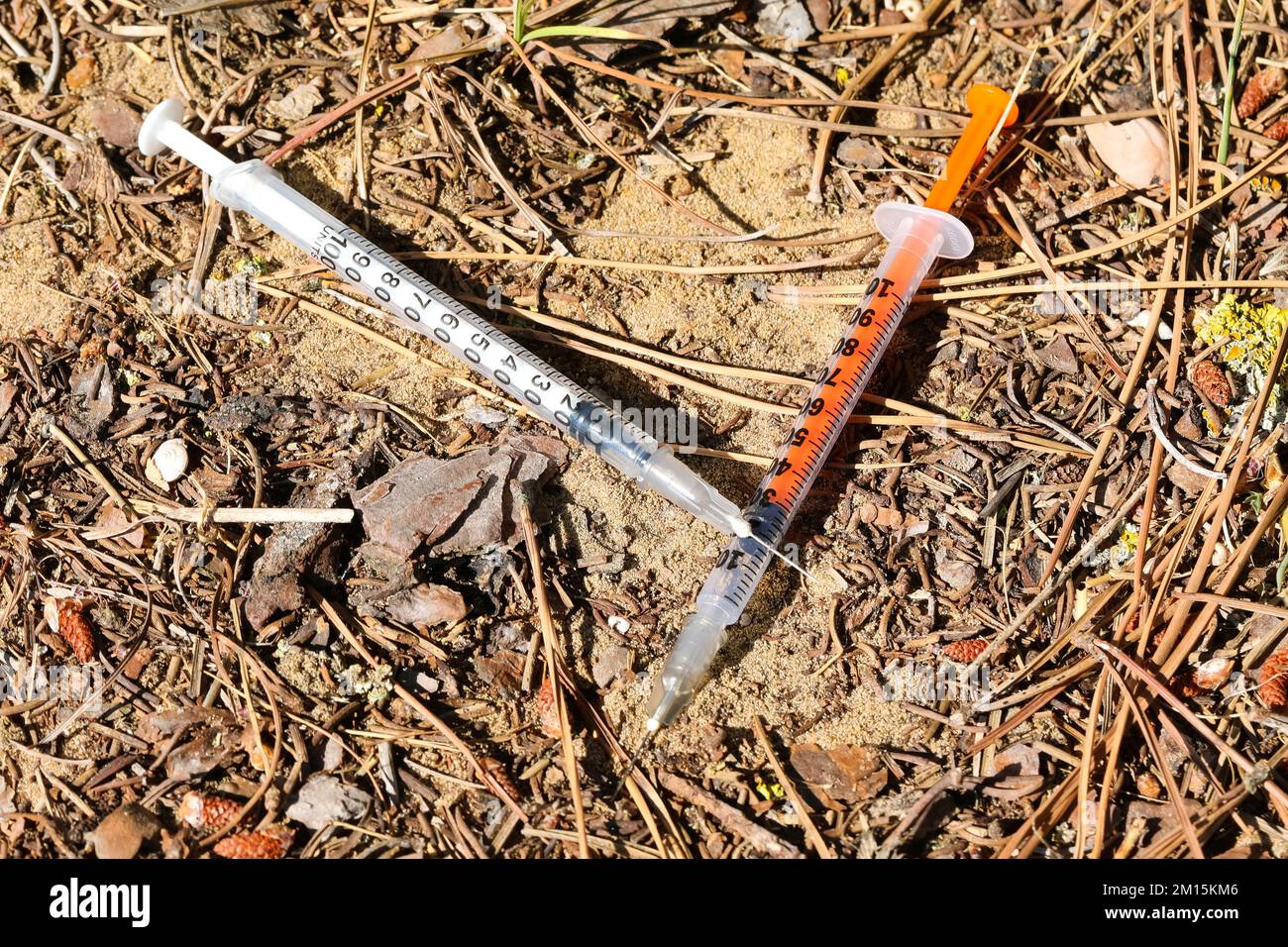 two abandoned syringes used by drug addicts in public park Stock Photo ...