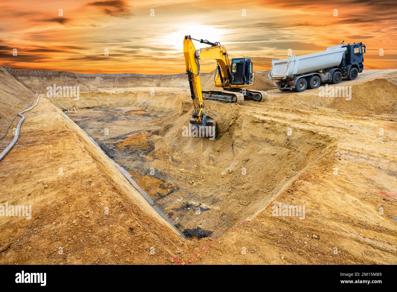 excavator is working and digging at construction site Stock Photo - Alamy