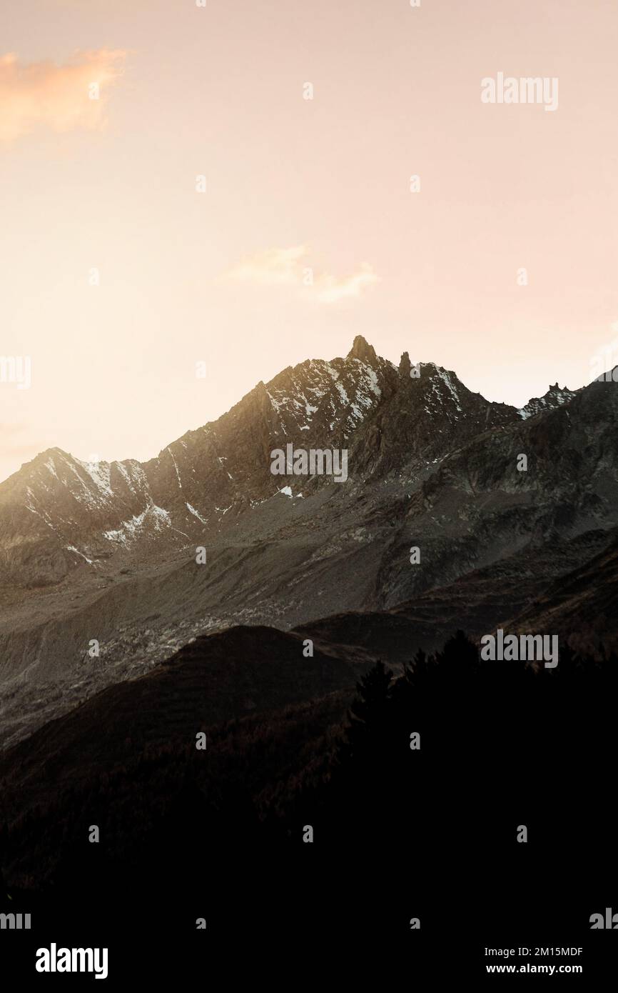 A breathtaking vertical shot of the rocky mountains at a sunrise Stock ...