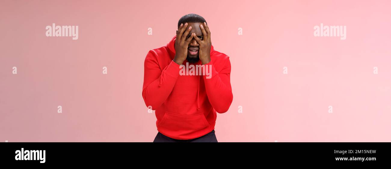 Shocked upset young african american bearded guy in red hoodie facepalm ...