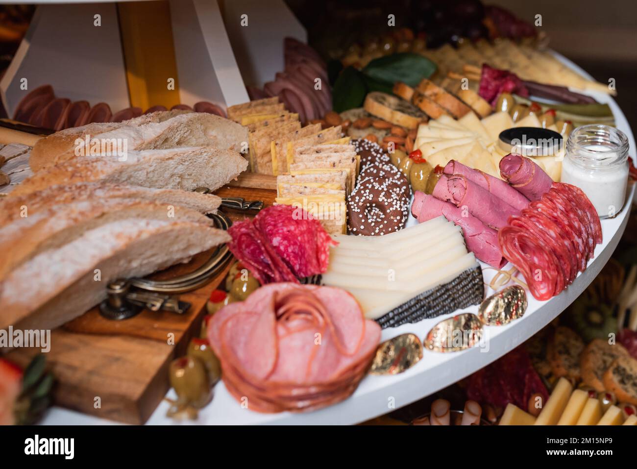 A closeup shot of a gourmet charcuterie board with salami, cheese, and ...