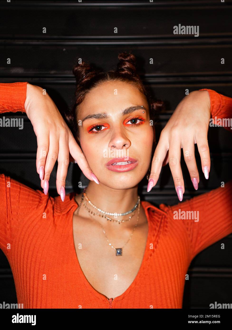 Portrait of attractive young female with orange eyeshadow and eyebrow ...