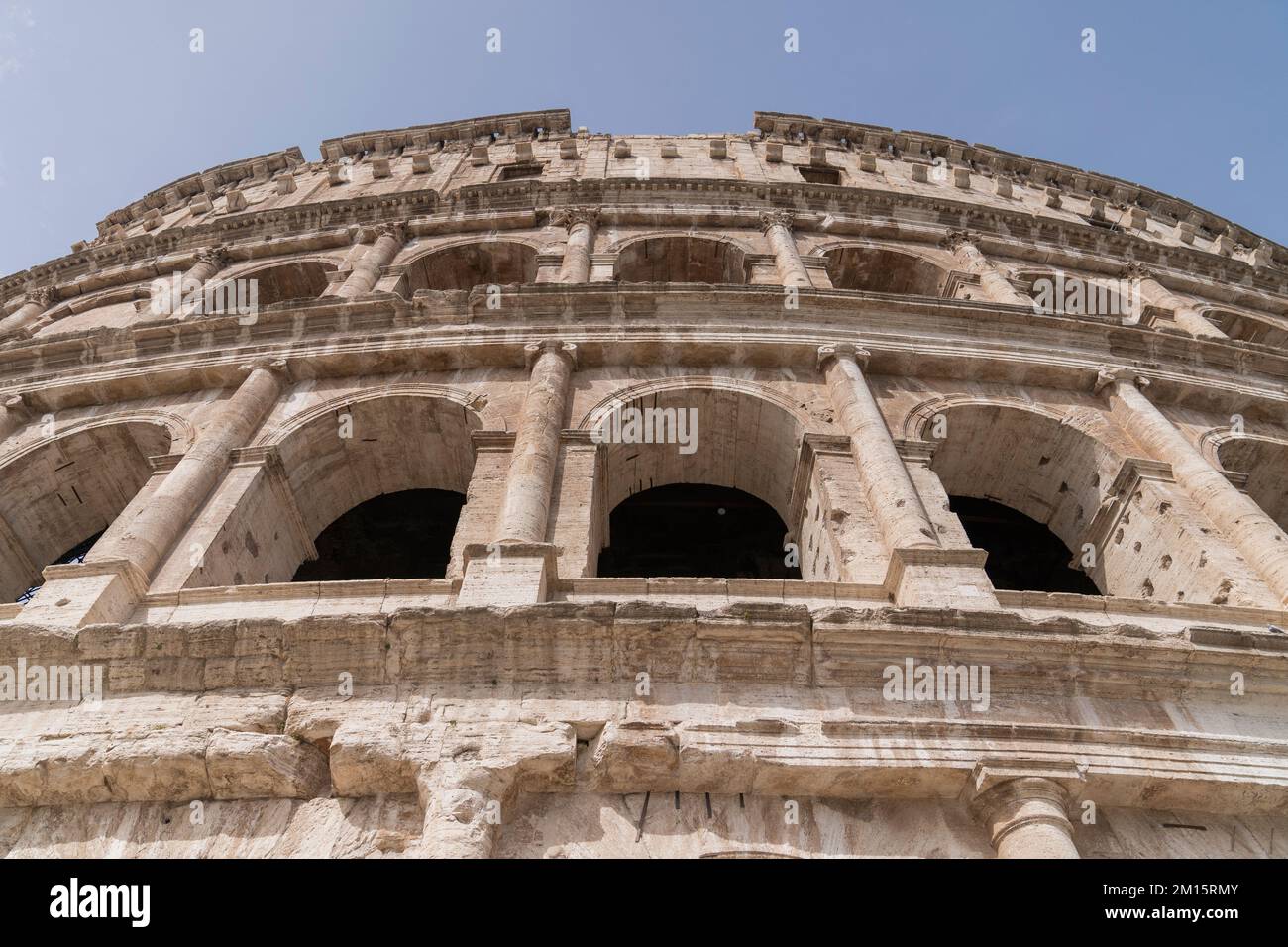 Low angle of famous Colosseum buildings with arches located against ...