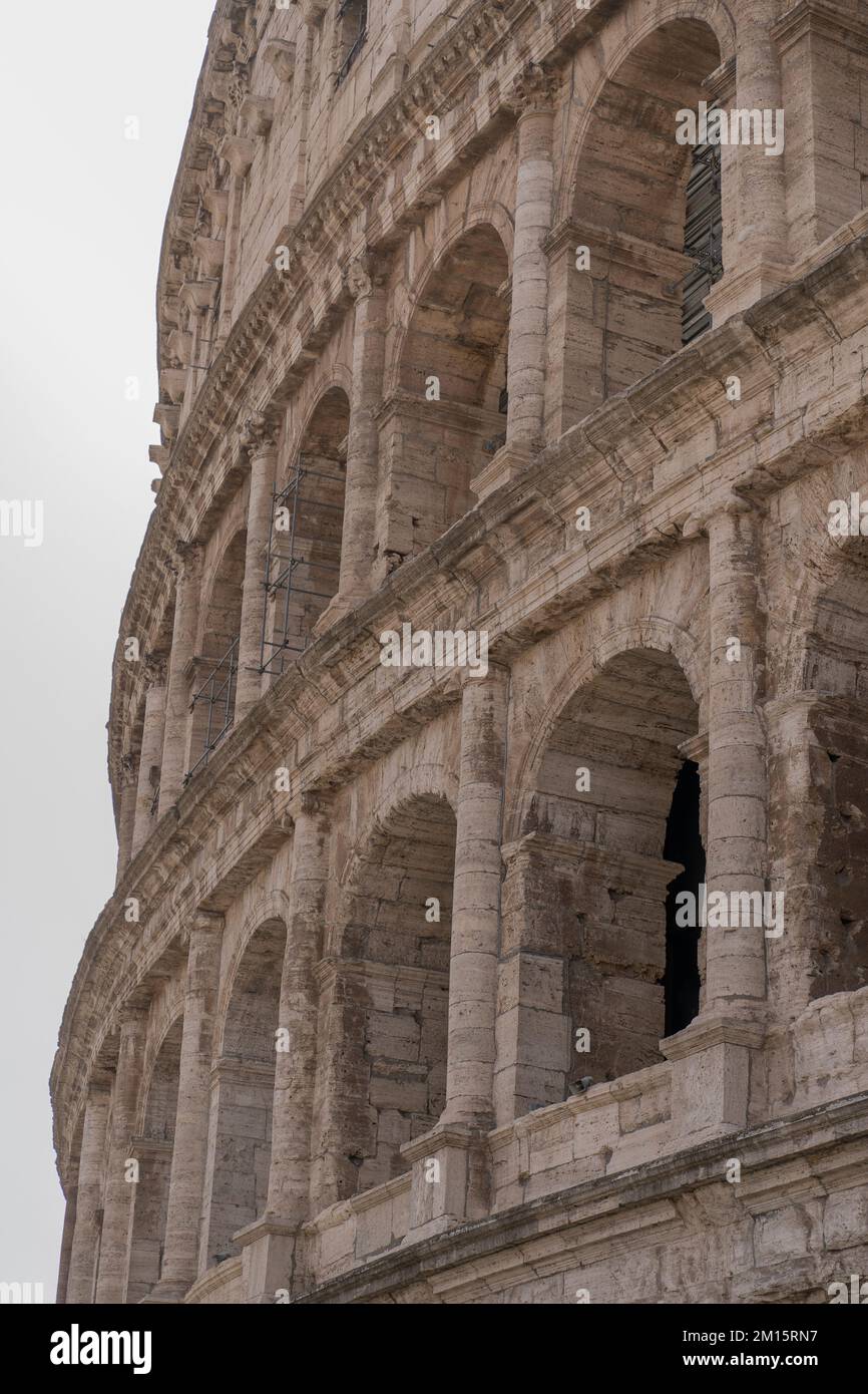 Low angle of famous Colosseum buildings with arches located against ...