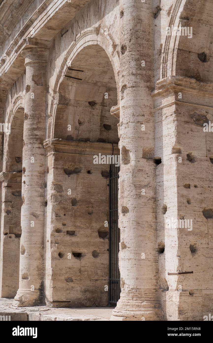 Low angle of famous Colosseum buildings with arches located against ...