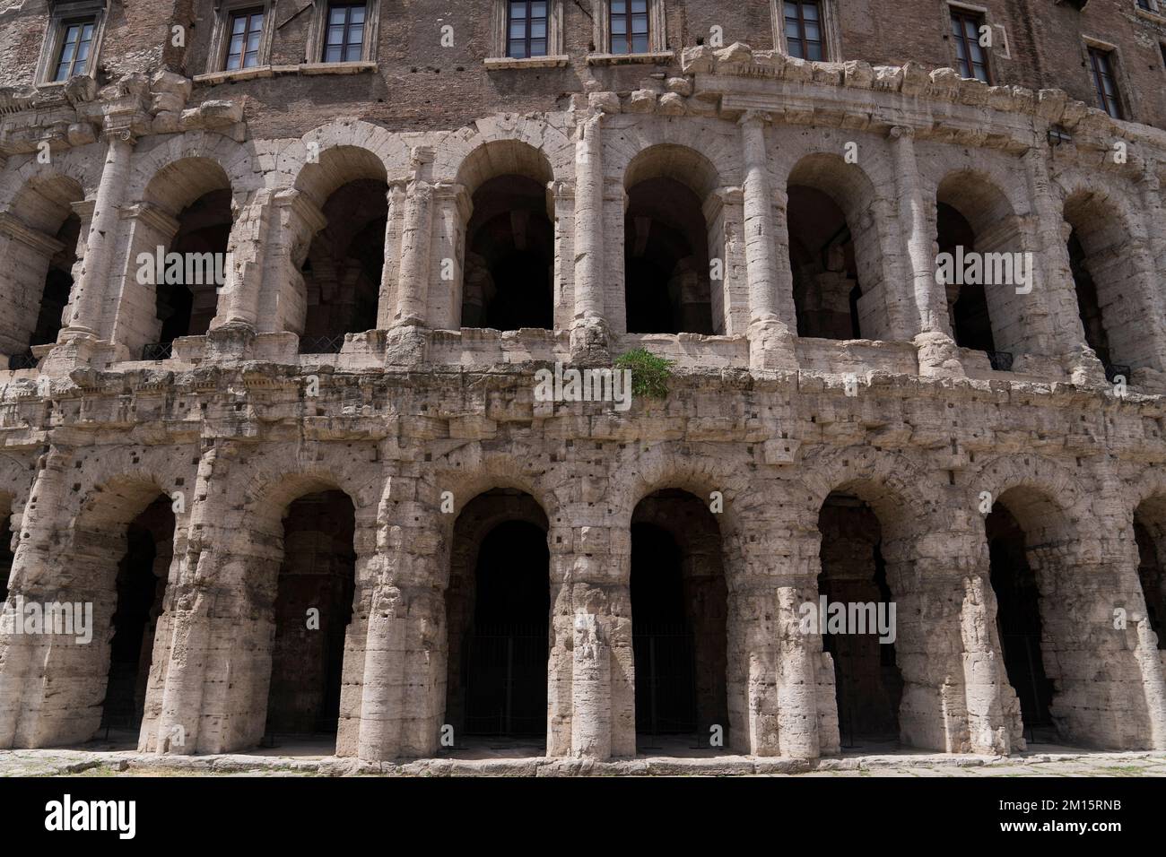 Exterior of Theatre of Marcellus with damaged sunlit arches and columns ...