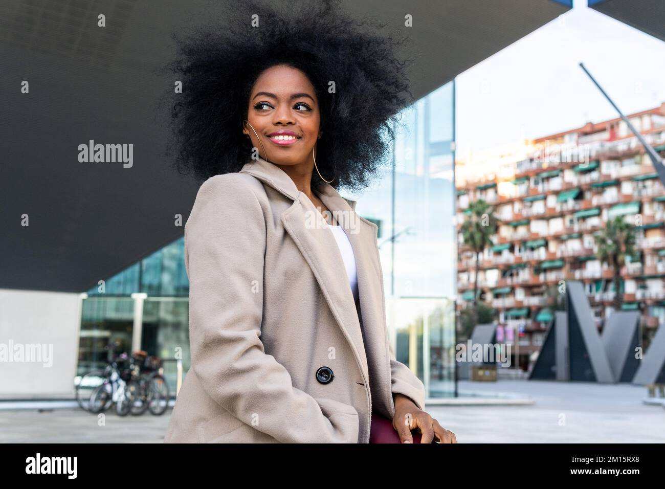 Low angle of confident young African American female with fro hair ...