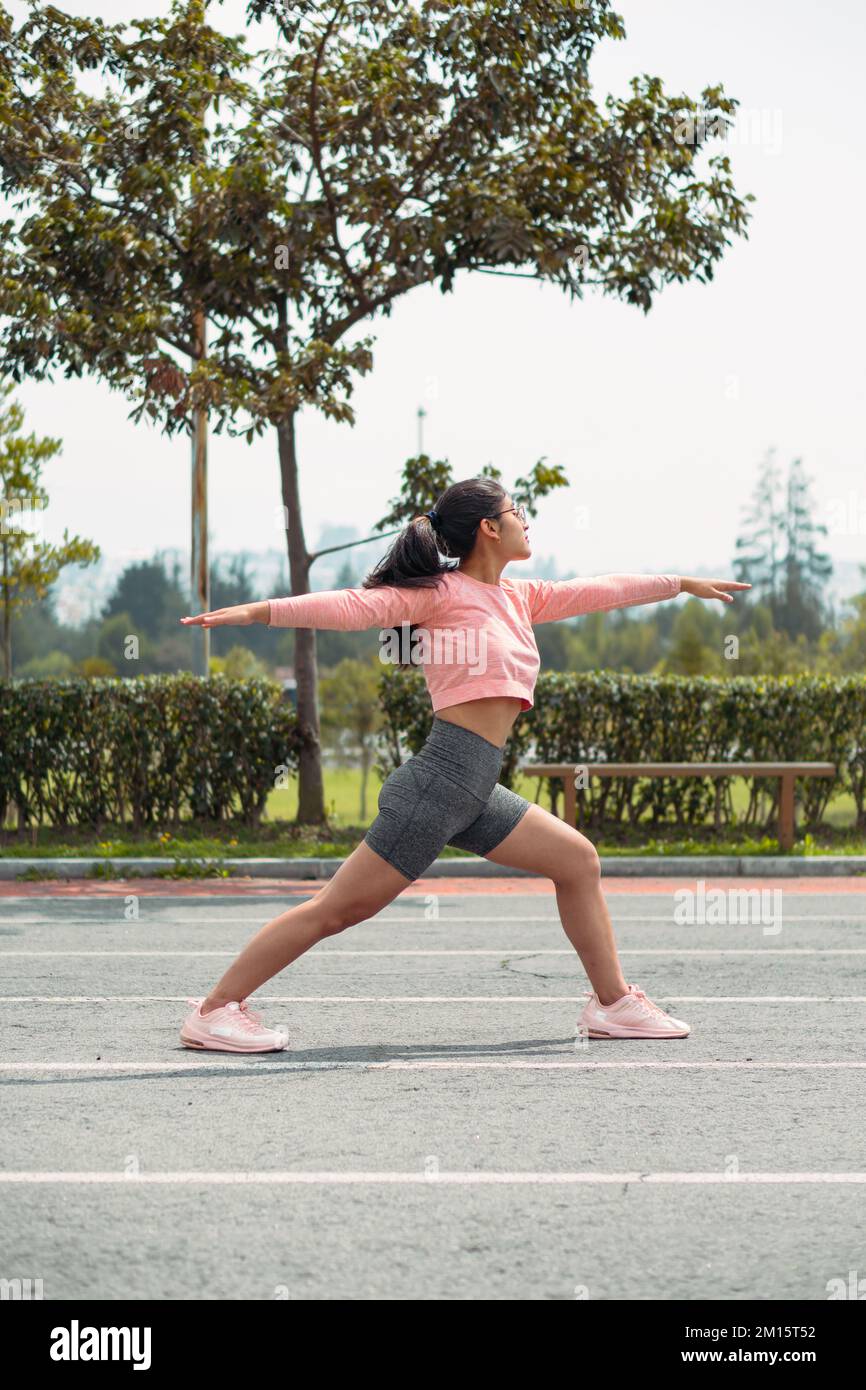 Side view full body of young female athlete in activewear with ponytail ...