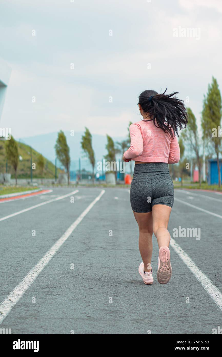 Full body back view of unrecognizable sportive female in sportswear ...
