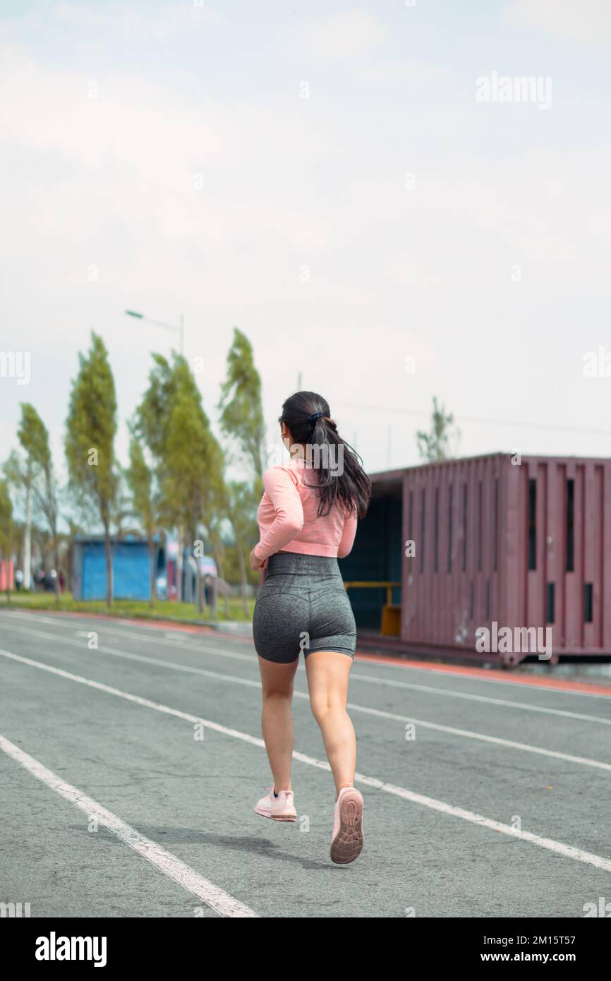 Full body back view of unrecognizable sportive female in sportswear ...