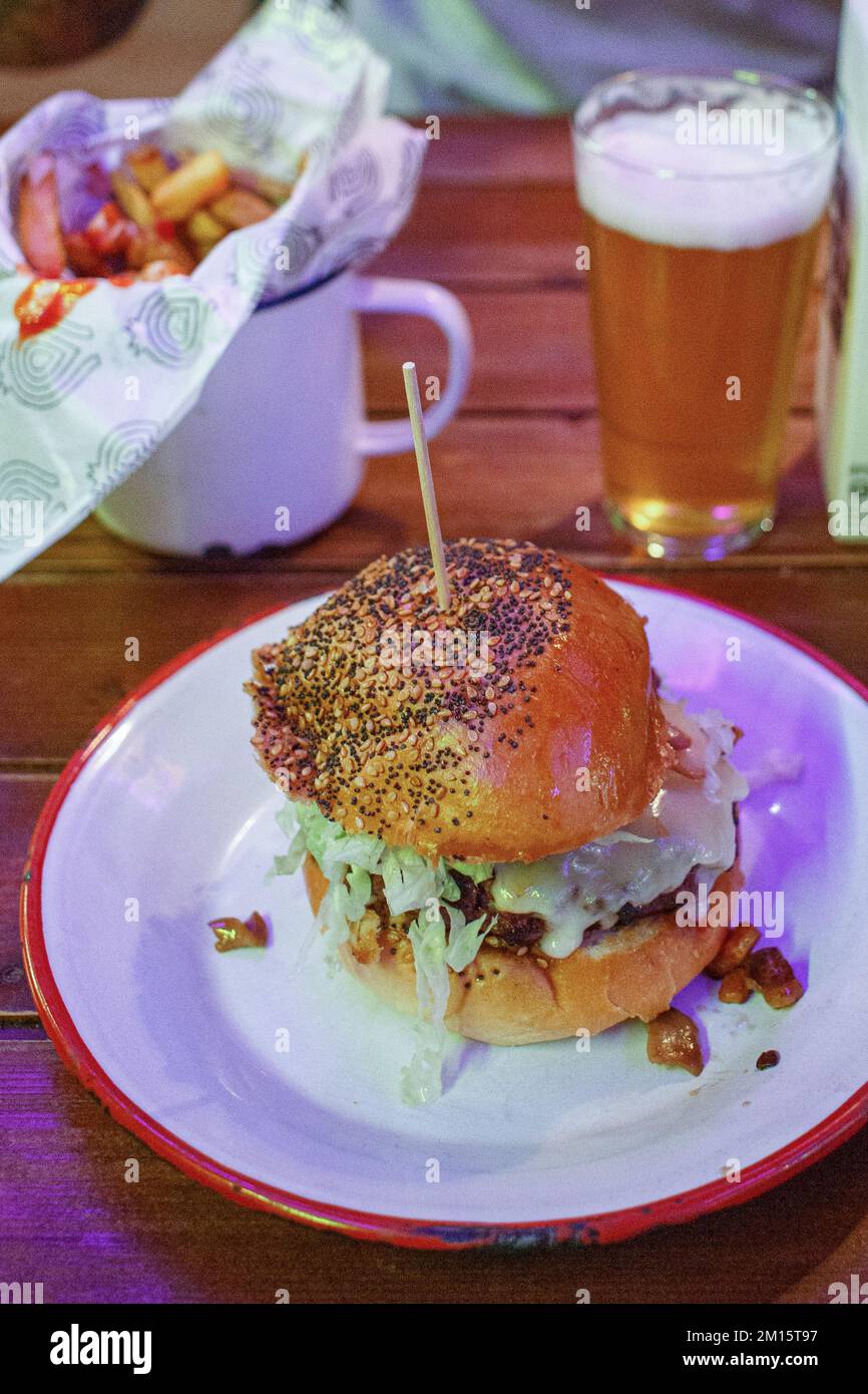 Delicious burger with meat, lettuce and cheese served on plate in ...
