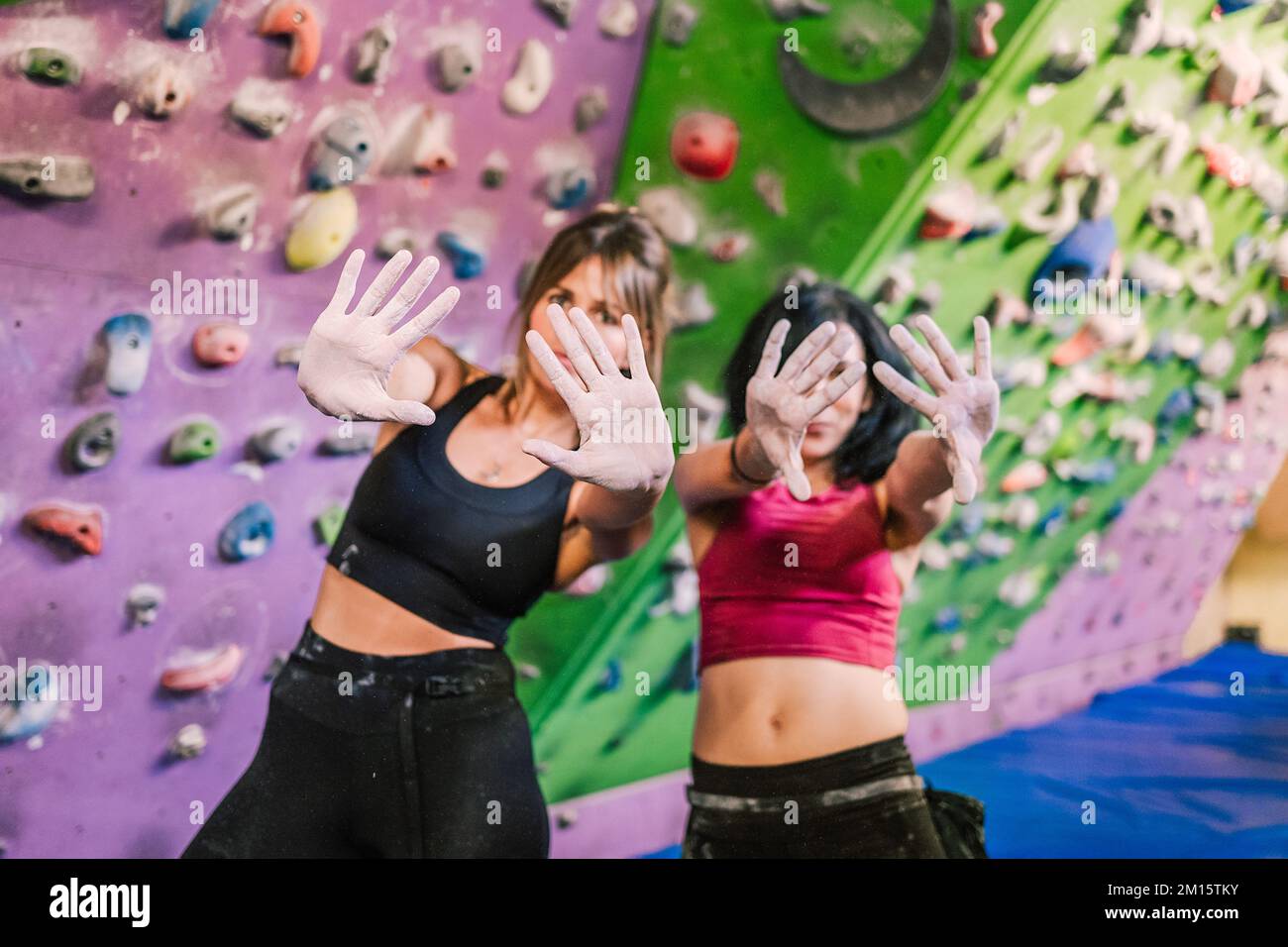 Soft focus of sportswomen in activewear demonstrating hands covered ...