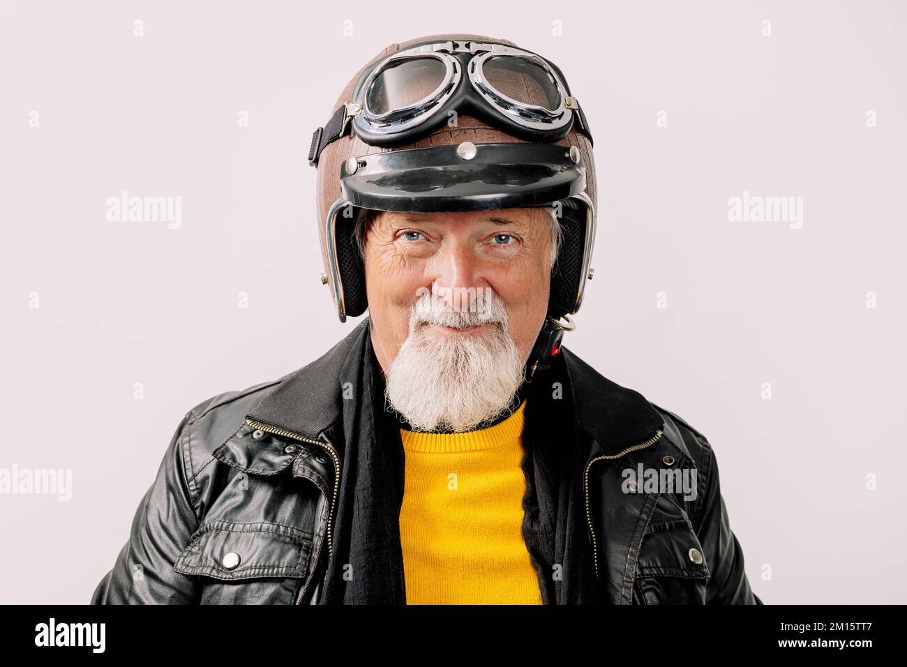 Portrait of smiling aged bearded male biker in leather jacket and ...