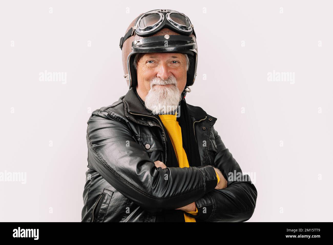 Portrait of smiling aged bearded male biker in leather jacket and ...