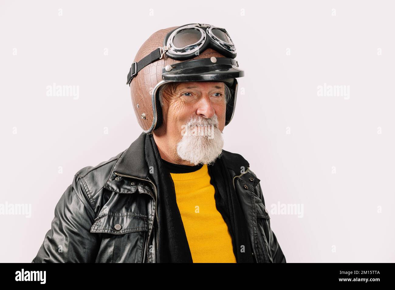 Portrait of smiling aged bearded male biker in leather jacket and ...