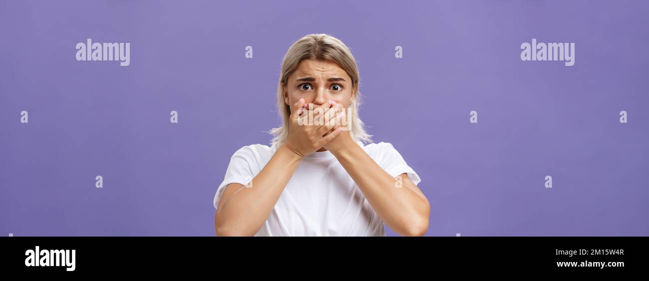 Waist-up shot of shocked nervous and scared young woman witnessing ...