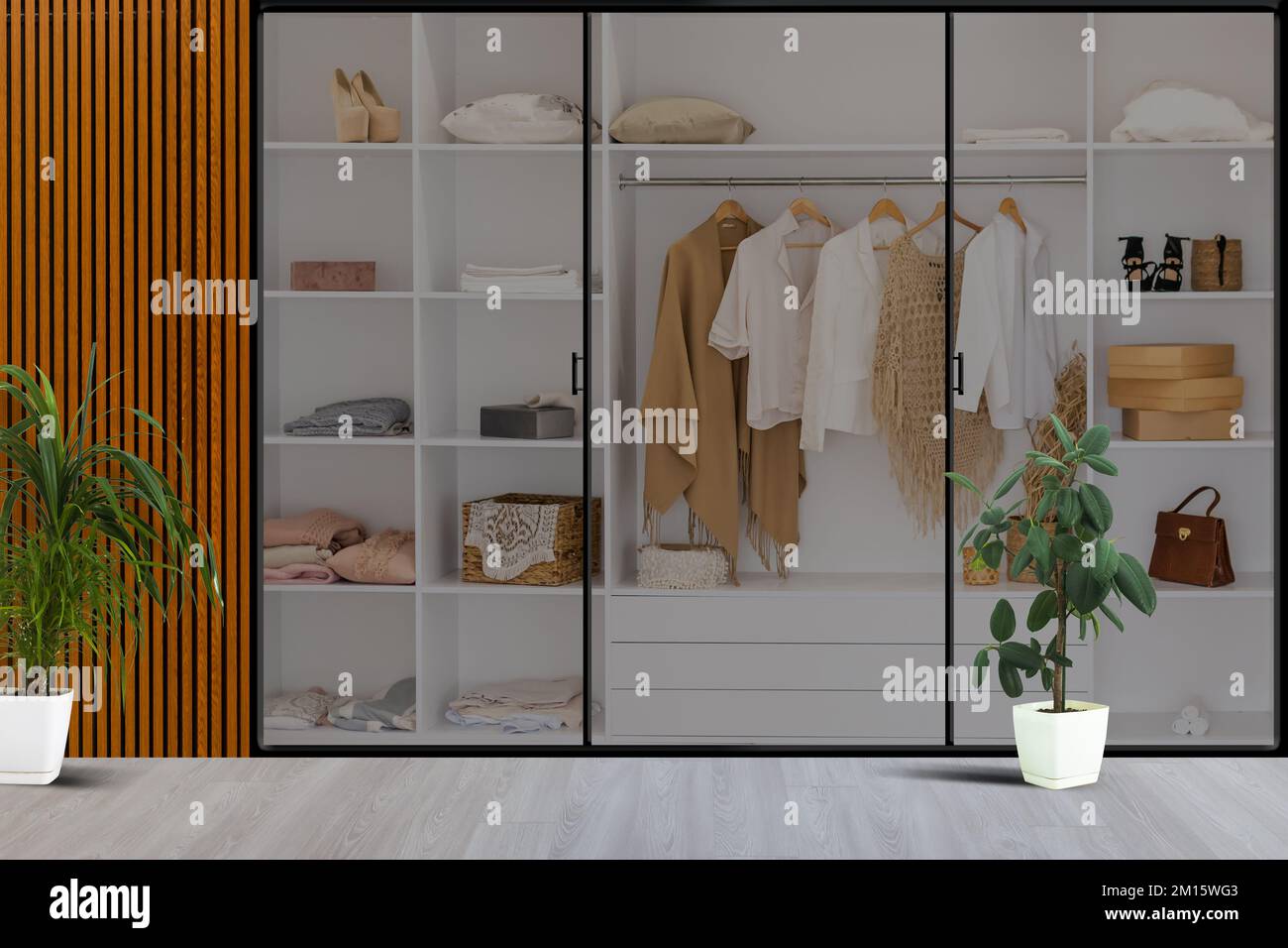 Big wardrobe with different clothes for dressing room. Interior ...