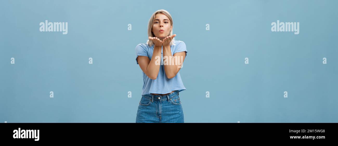Studio shot of attractive and romantic european blonde girlfriend in ...