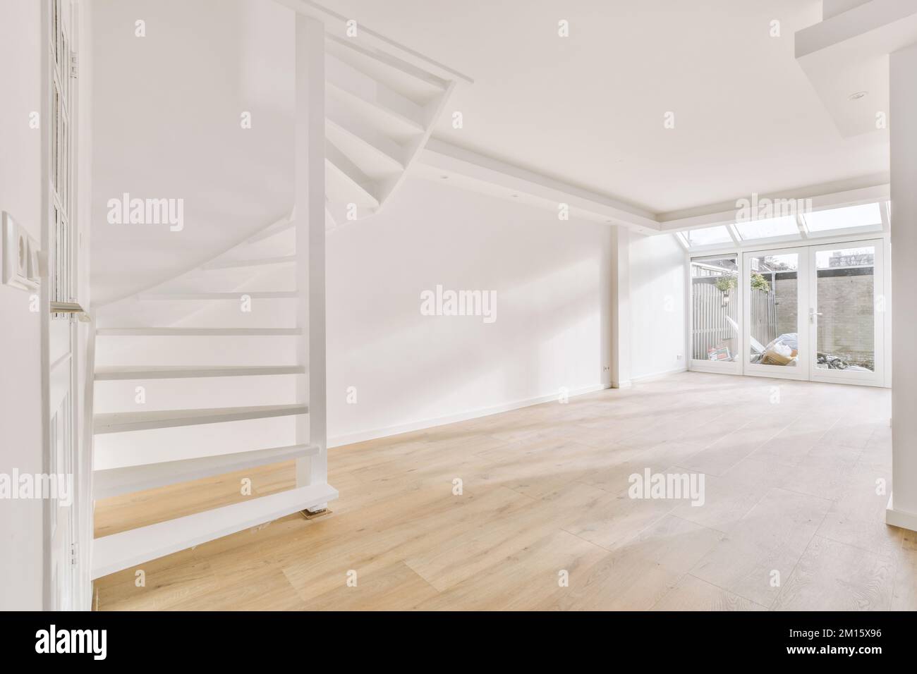 Empty light room with big windows and stairs at ground floor at home ...