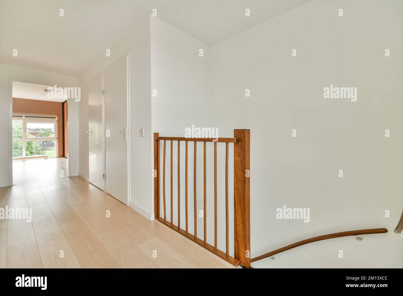 Interior of a house with stairs to an down floor in a bright ...