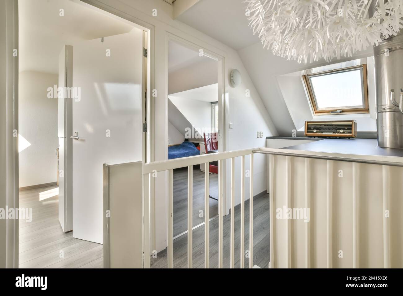 Corridor in mansard with staircase leading down and wooden floor in ...