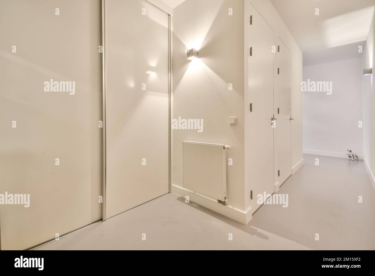 Interior passage way with radiator on wall in modern house Stock Photo ...