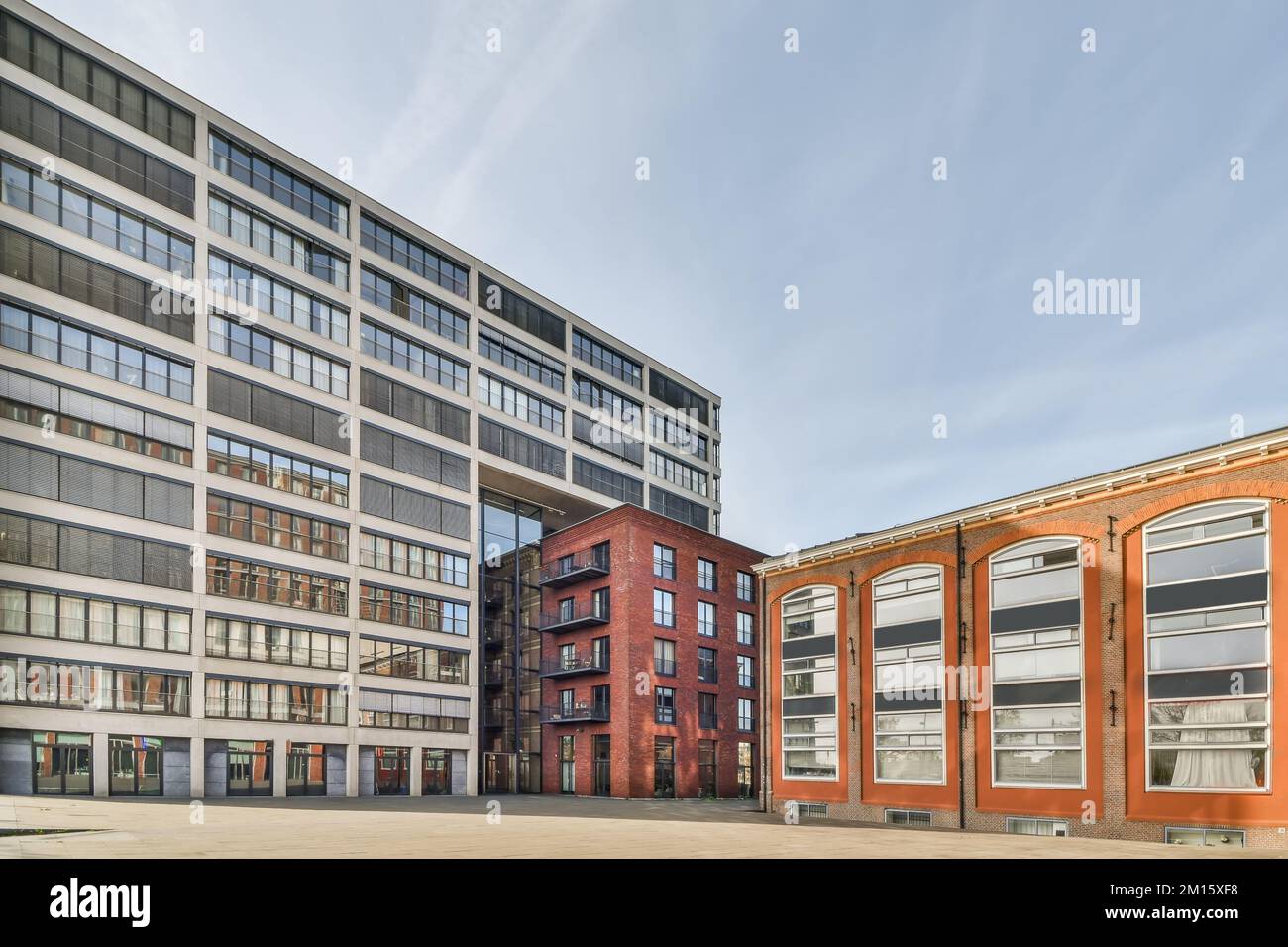 In perspective modern building under a sky with clouds Stock Photo - Alamy