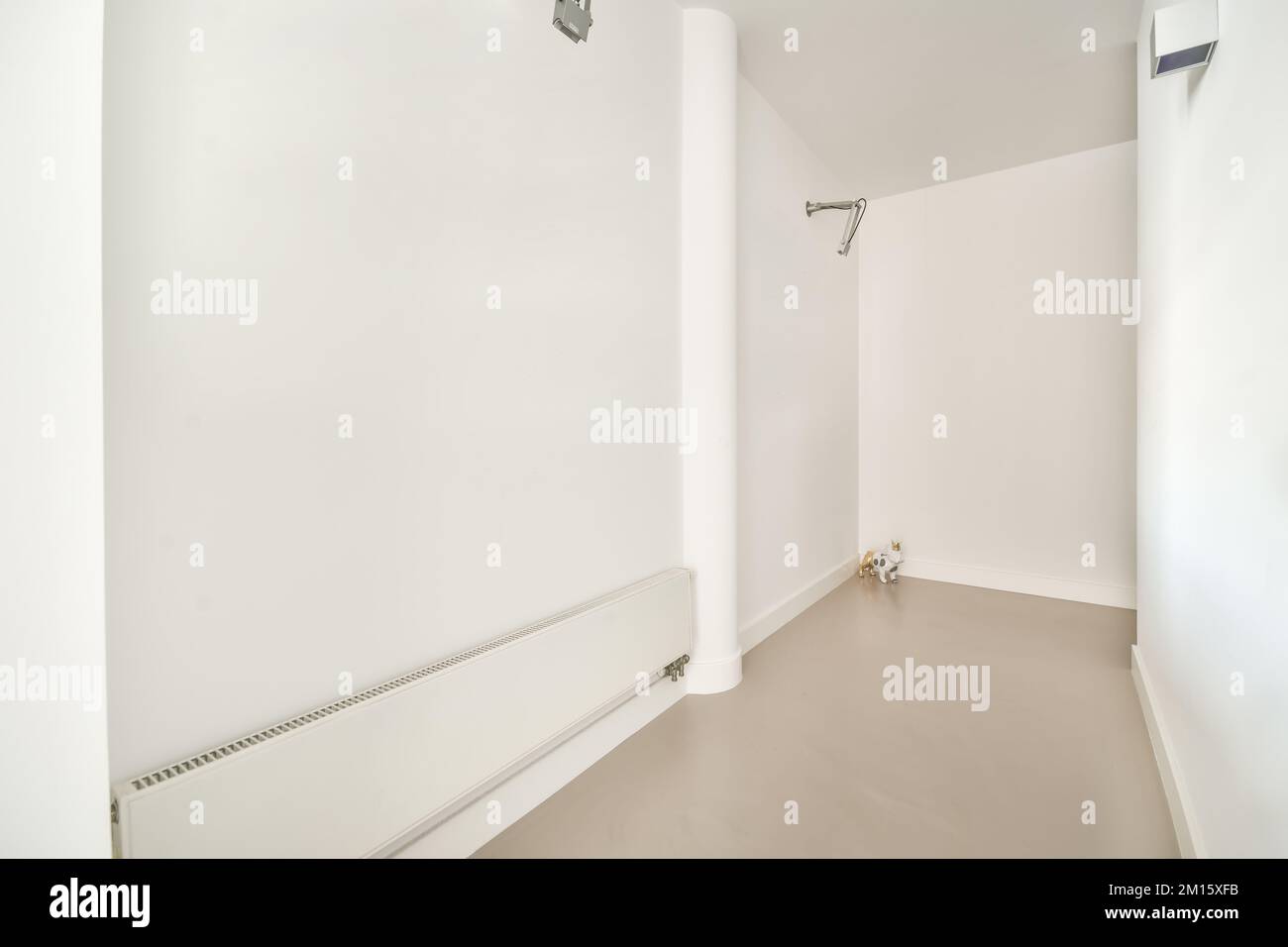Interior passage way with radiator on wall in modern house Stock Photo ...